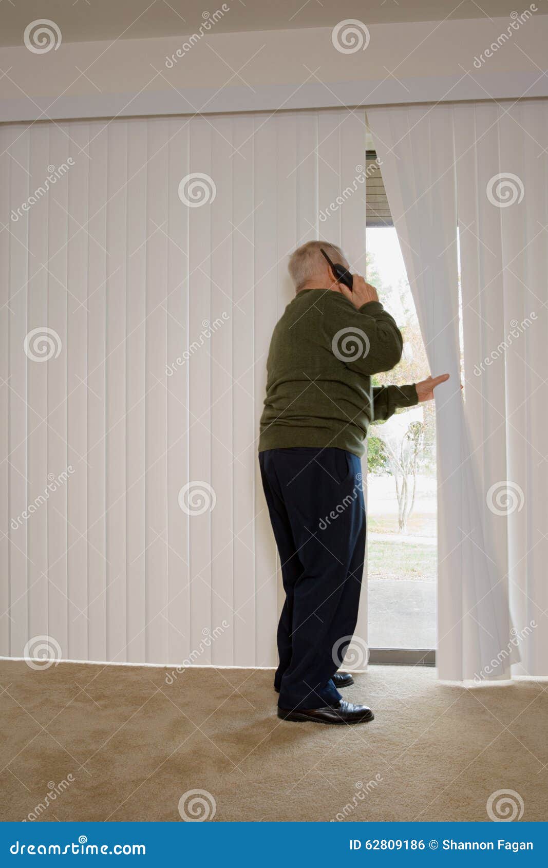 Elderly Man on Phone and Looking Out of Window Stock Photo - Image of ...
