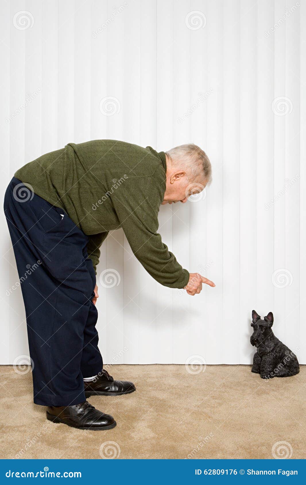 Elderly Man Pointing at Dog Ornament Stock Photo - Image of people ...