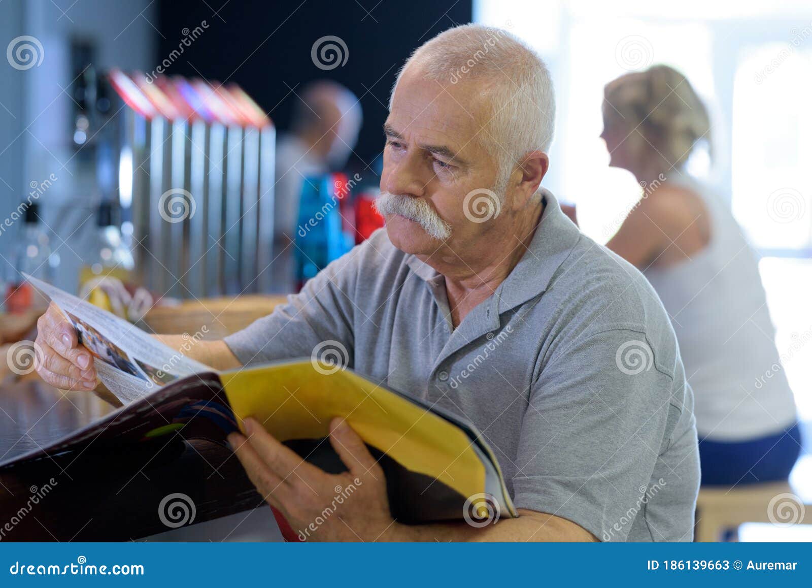 Elderly Man Reading Magazine in Cafe Stock Image - Image of page ...