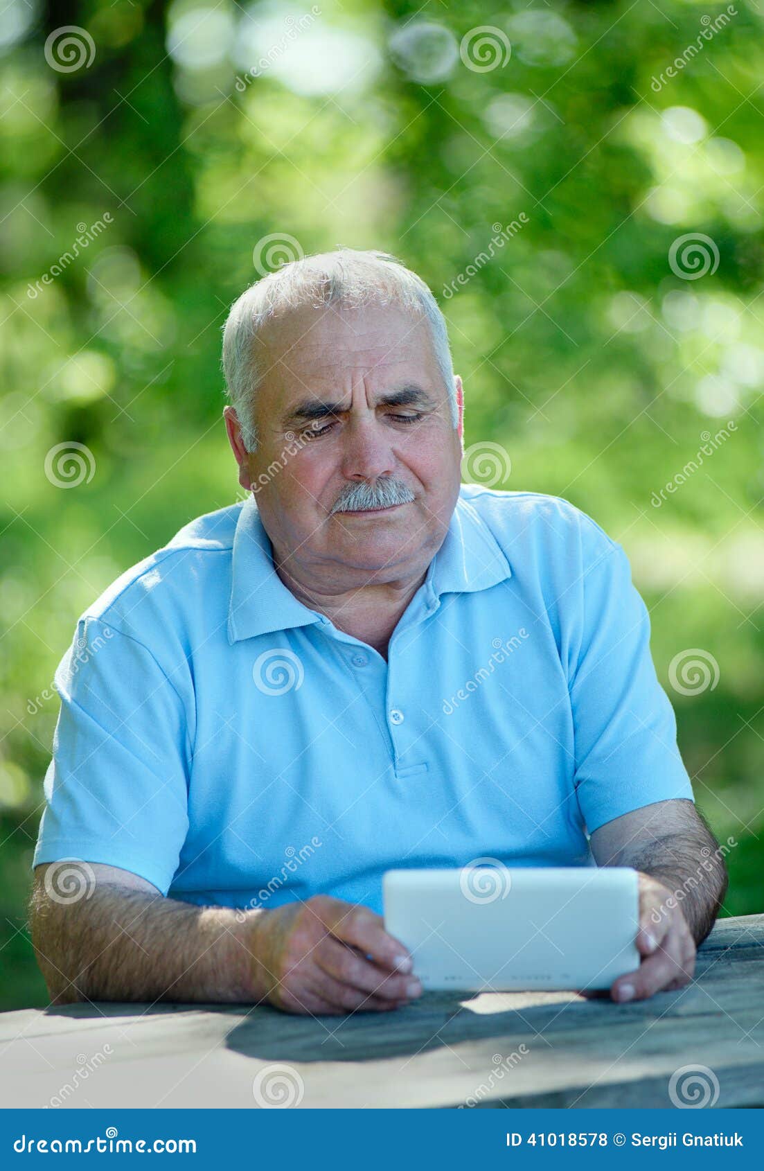 Elderly Man Reading on a Tablet Computer Stock Photo - Image of ...