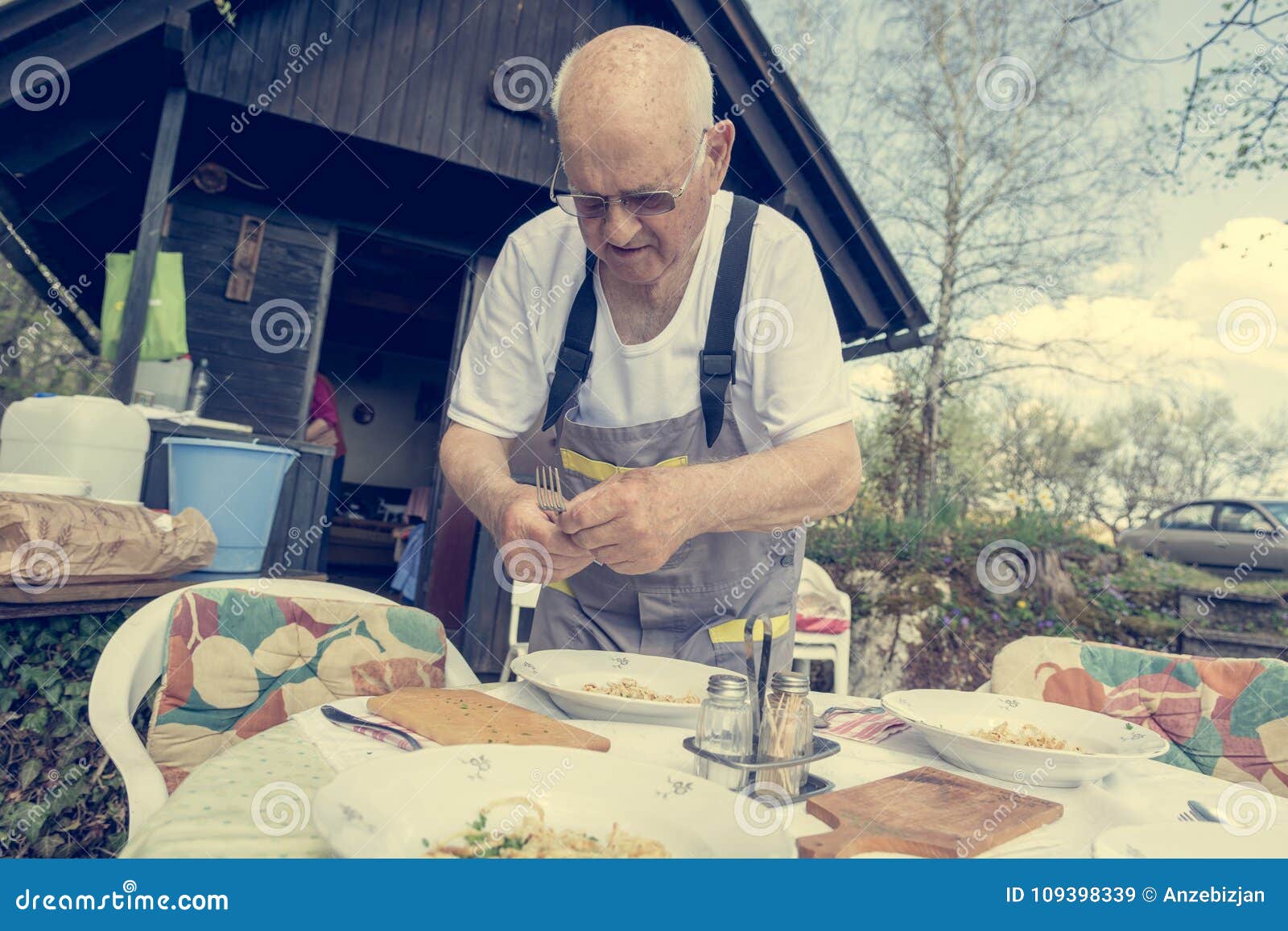 Elderly Man Setting a Table Outside. Stock Image - Image of vintage ...