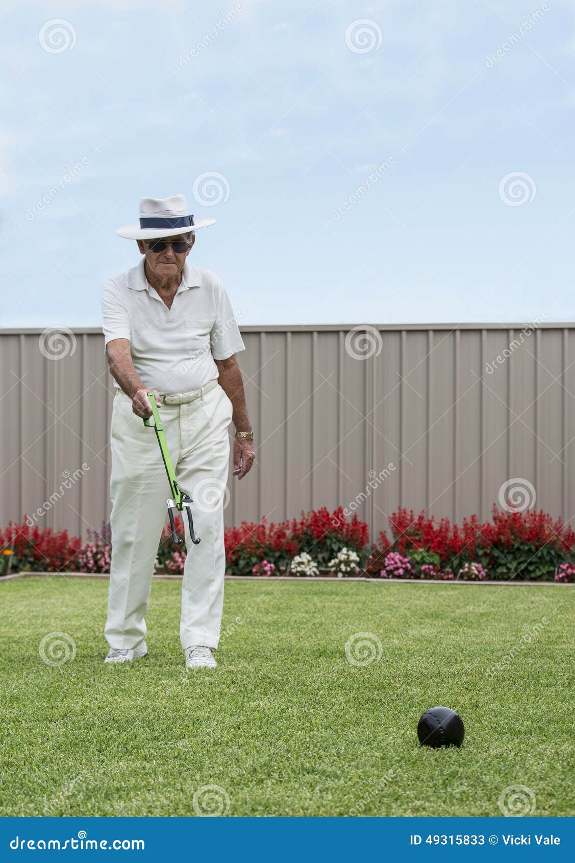 Elderly Man Rolling Ball with Artificial Bowling Arm. Stock Image ...