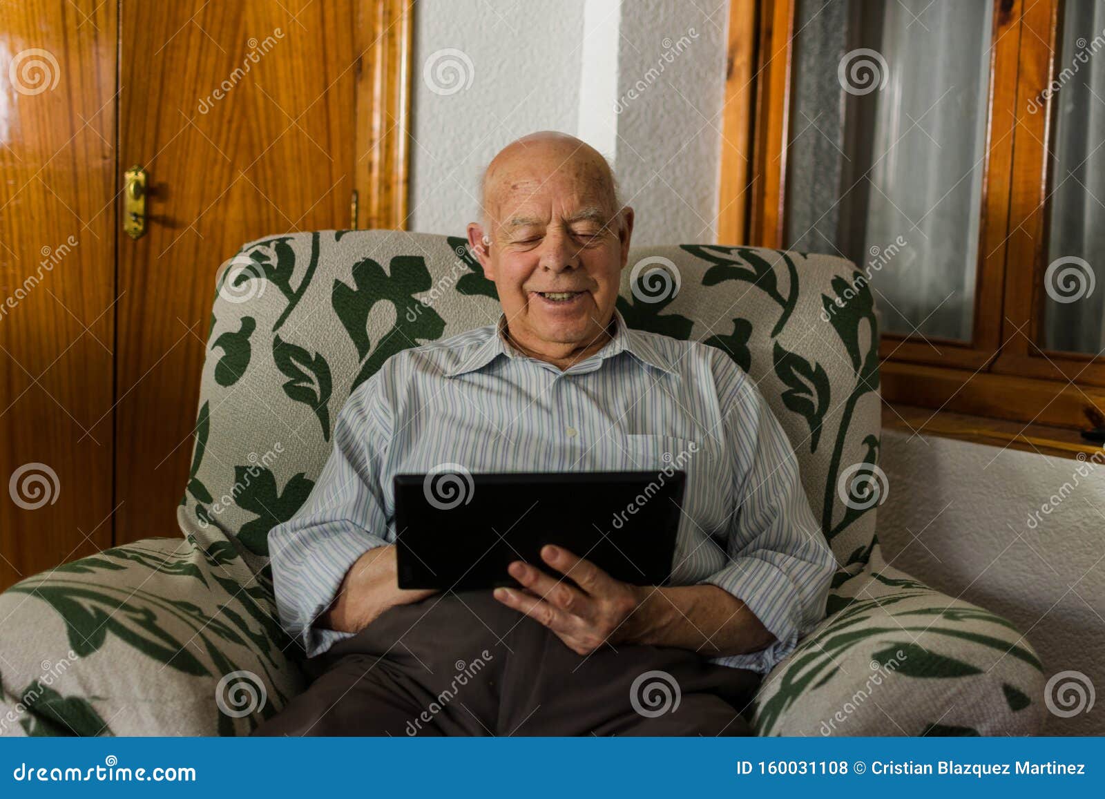 Elderly Man is Using a Digital Tablet at Home Stock Photo - Image of ...