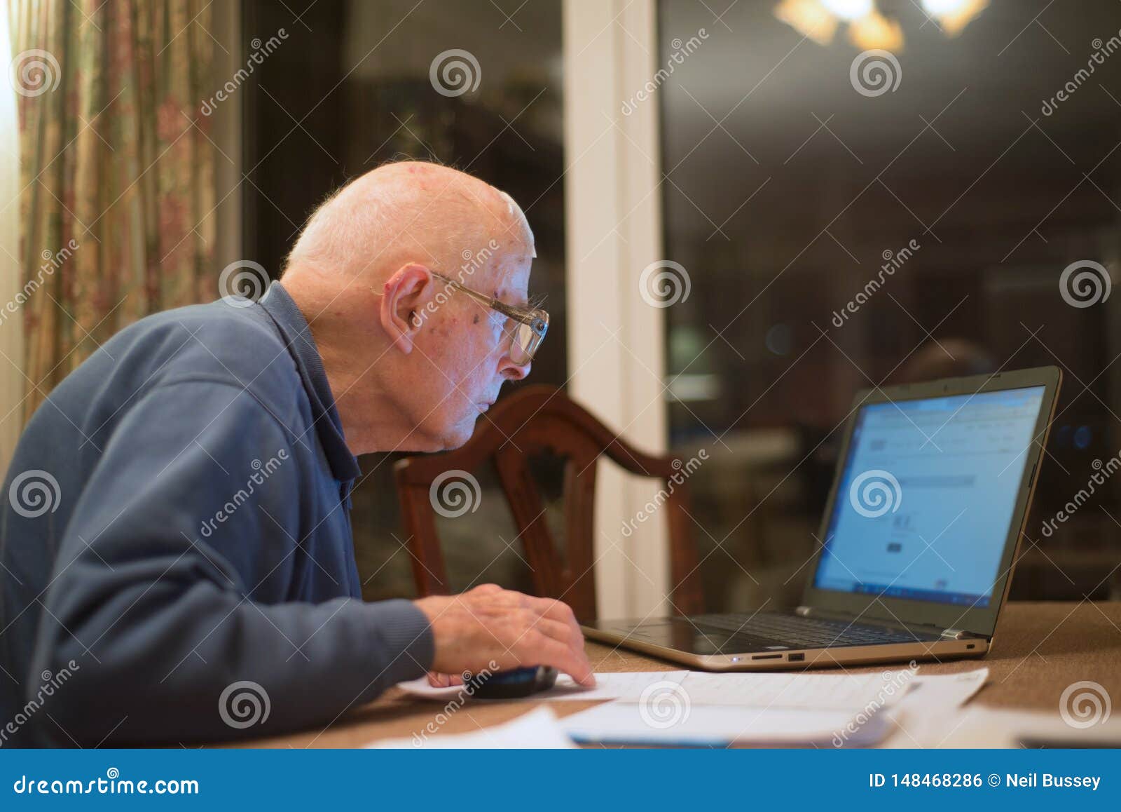 Elderly Man Using a Laptop Computer ,checking His Share Portfolios ... Elderly Man Using a Laptop Computer ,checking His Share Portfolios ...
