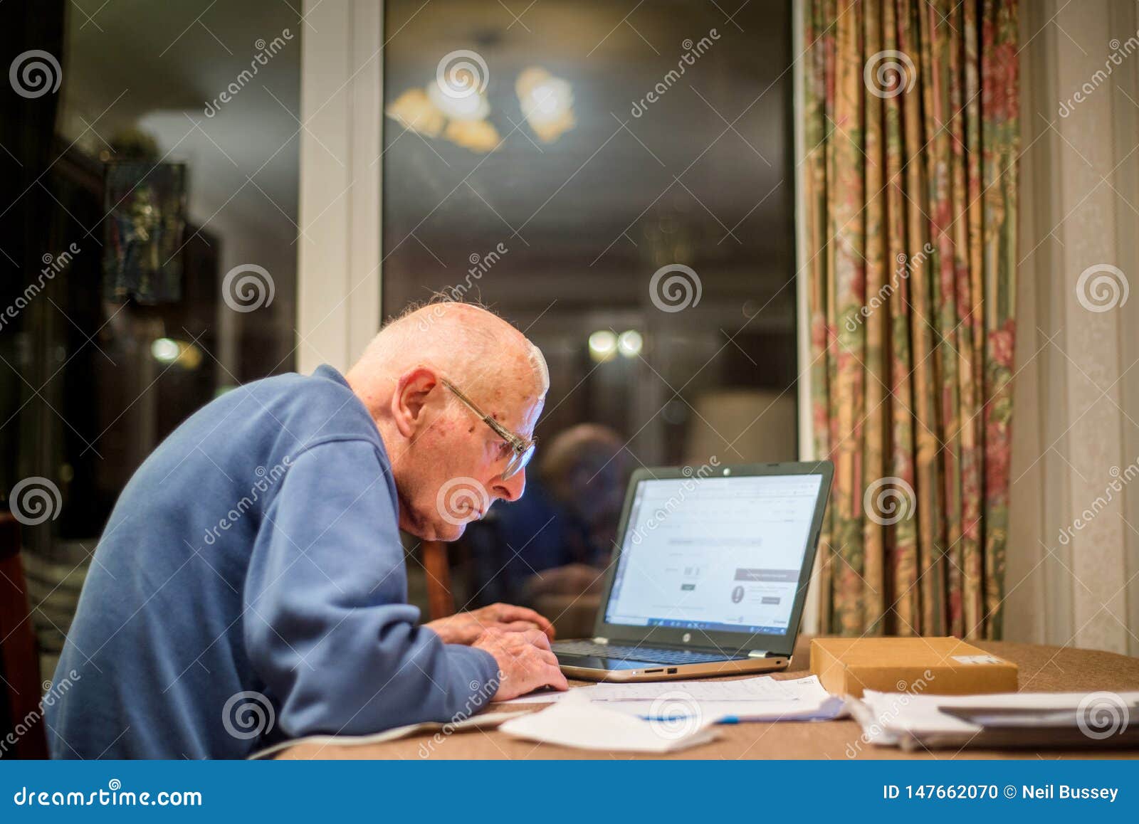 Elderly Man Using a Laptop Computer To Check His Finances ,Hampshire ... Elderly Man Using a Laptop Computer To Check His Finances ,Hampshire ...