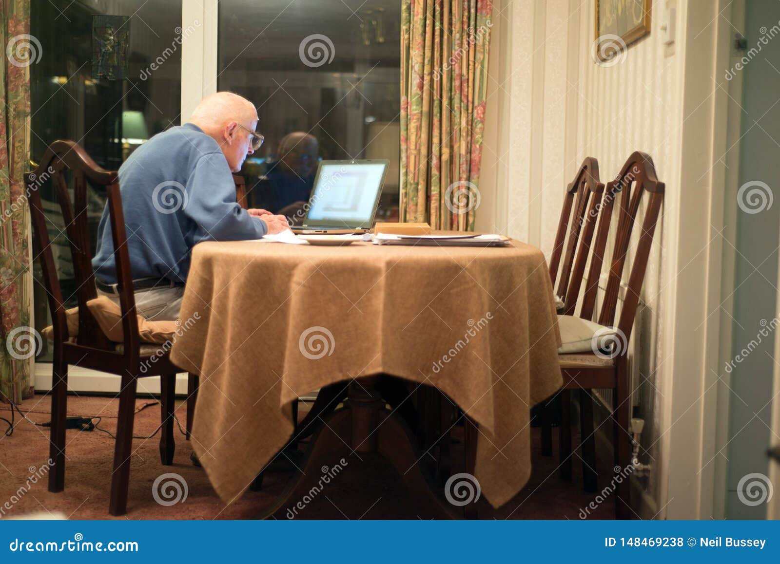 Elderly Man Using a Laptop Computer To Check His Share Portfolios ... Elderly Man Using a Laptop Computer To Check His Share Portfolios ...