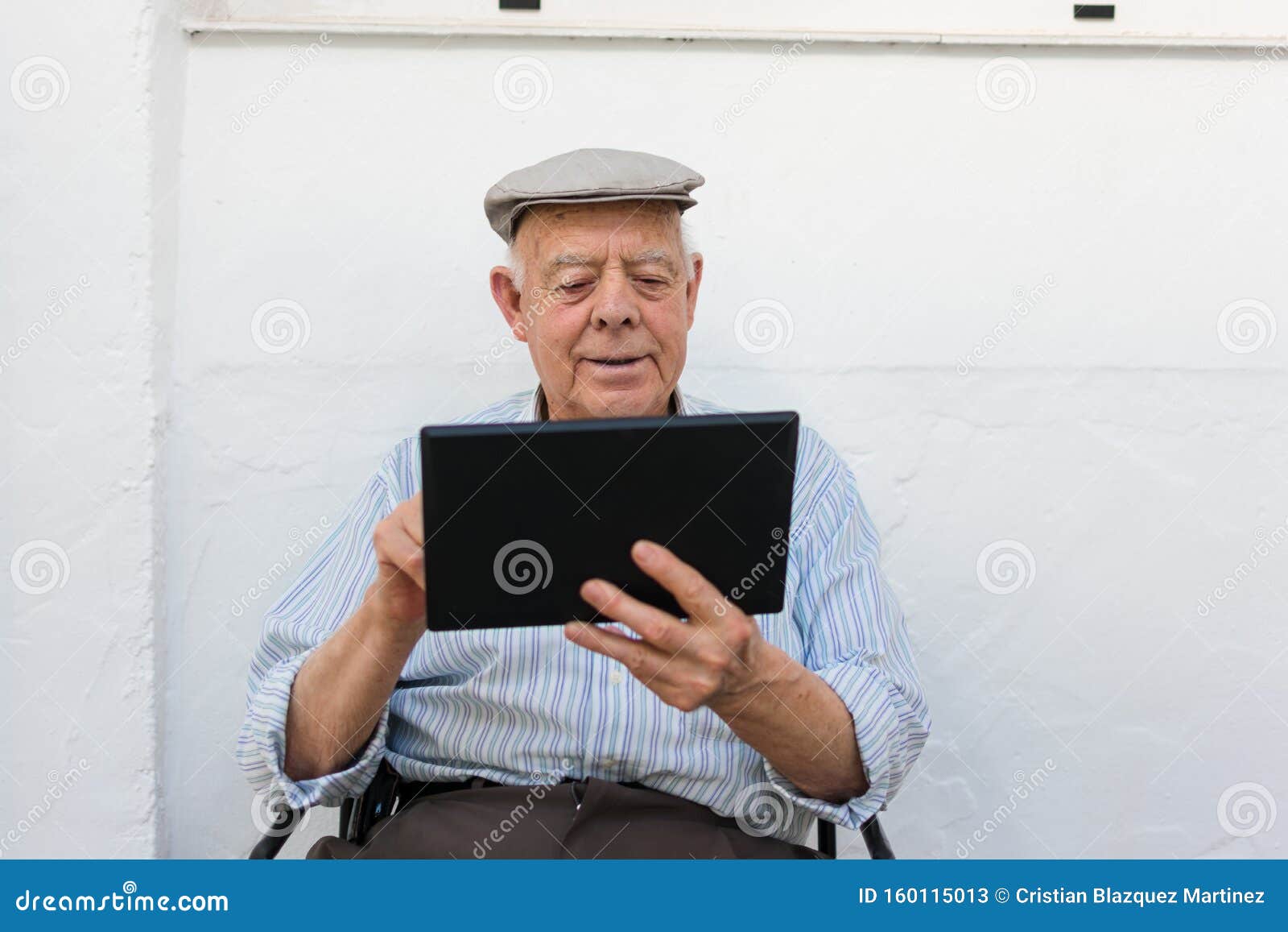 Elderly Man is Using a Tablet in the Yard of His House Stock Image ...