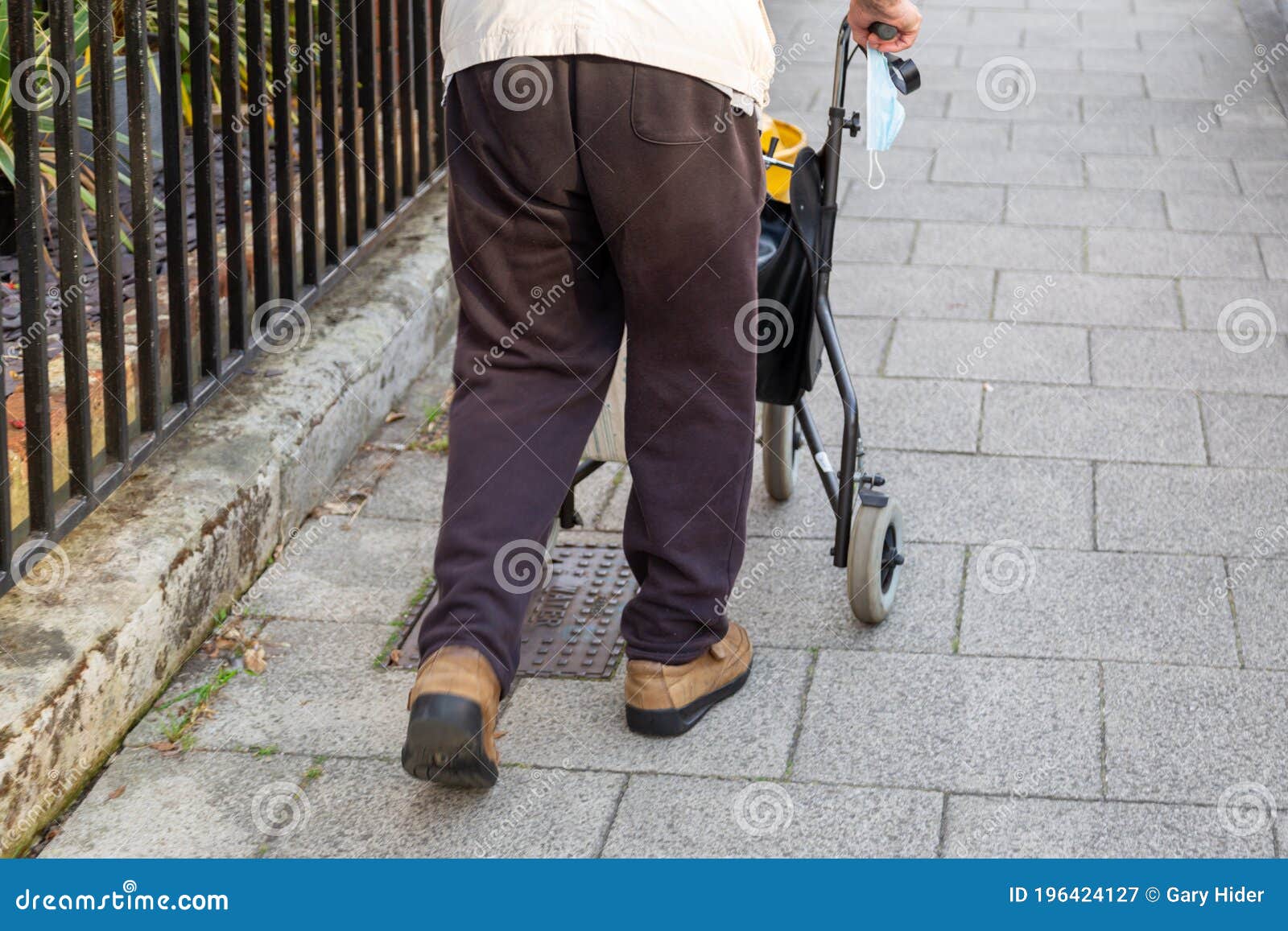 An Elderly Man Walking Using a Walking Aid or a Zimmer Frame Stock ...