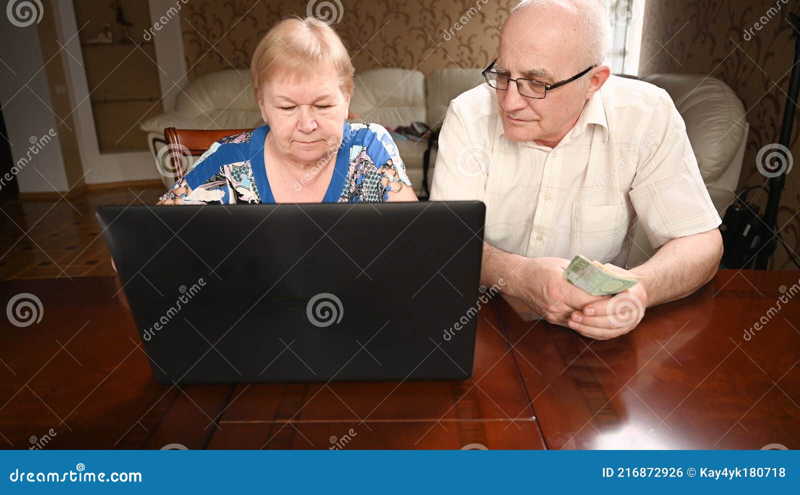 Elderly Married Couple Sitting at the Computer Makes Purchases on the ...