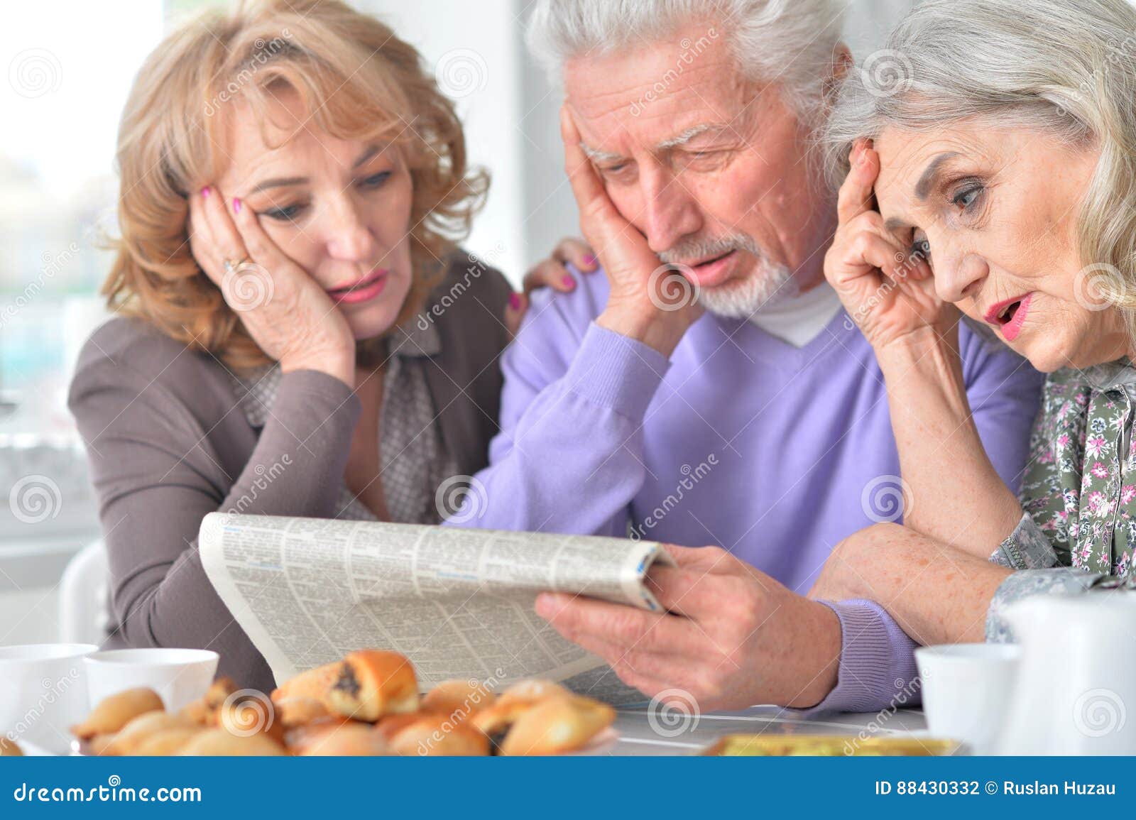 Elderly People Having Breakfast and Reading a Newspaper Stock Photo ...