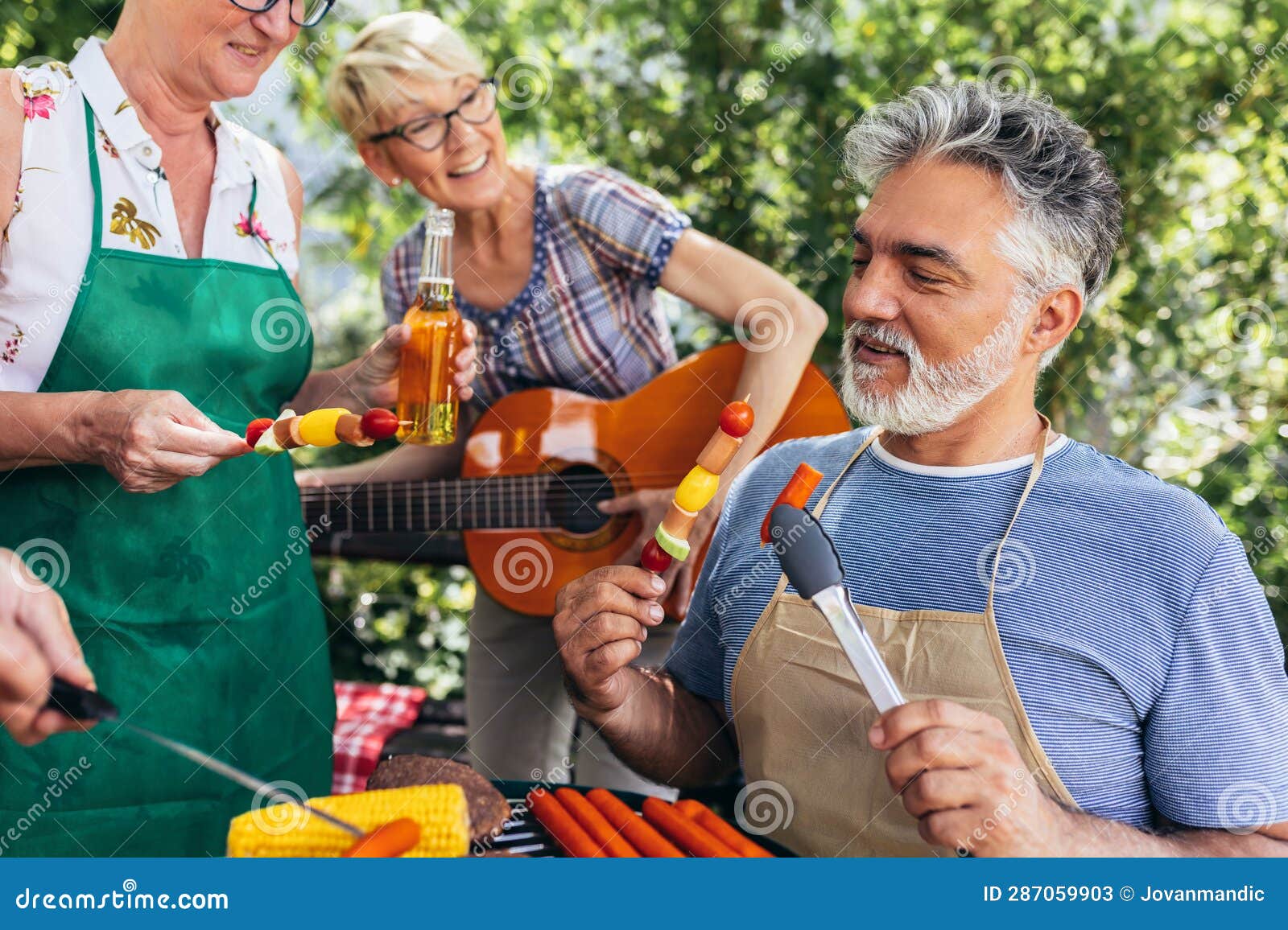 Senior People are Making Barbeque, Drinking Beverages, Making Memories ...