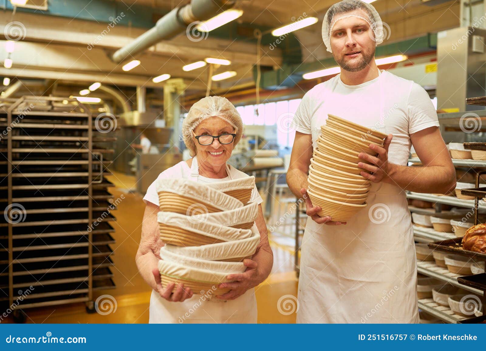 Elderly Woman As Baker and Young Apprentice with Bread Baskets Stock ...
