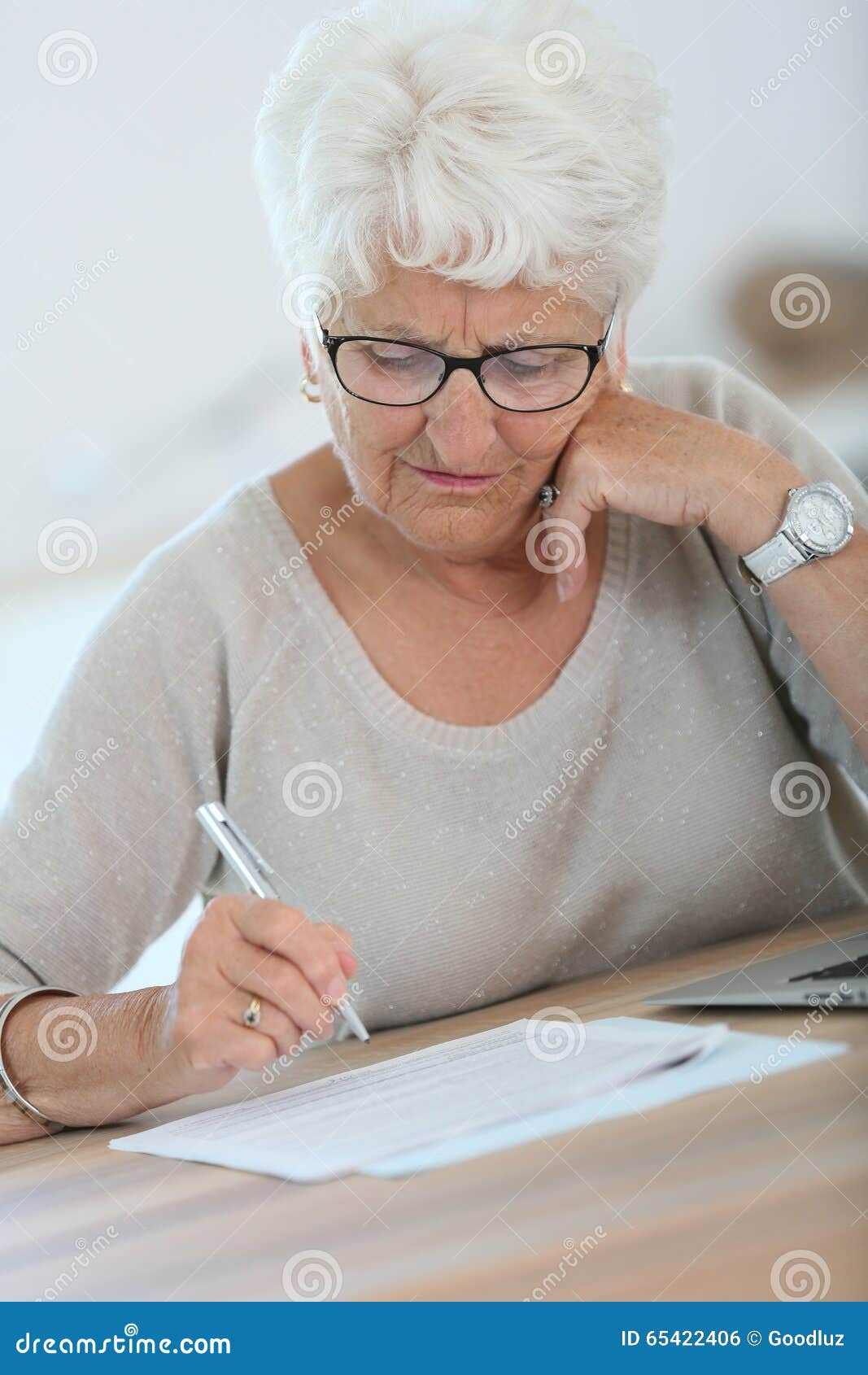 Elderly Woman Doing Paperwork with Laptop Stock Photo - Image of ...
