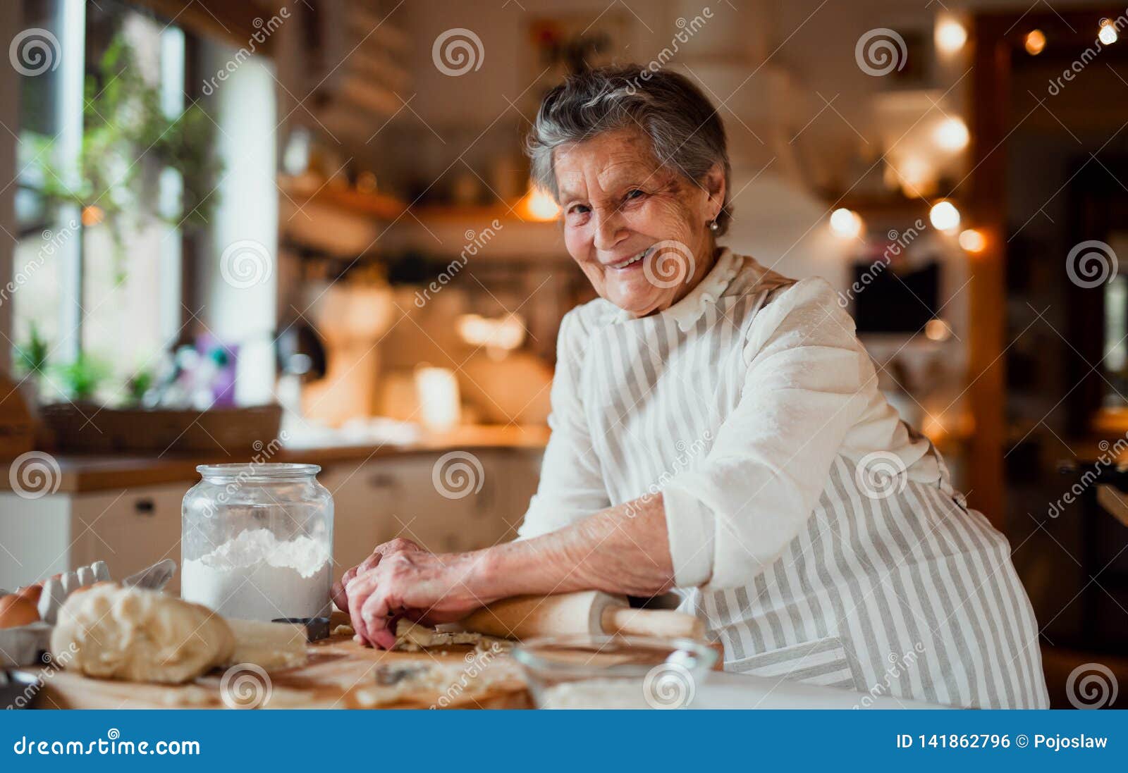 Elderly Woman Making Cakes in a Kitchen at Home. Copy Space Stock Photo ...