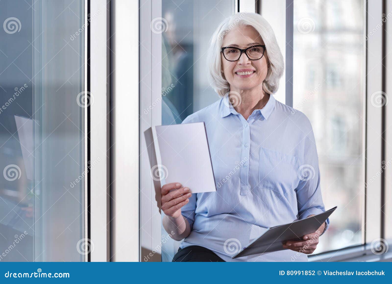 Elderly Woman Posing with Documents in an Office Stock Photo - Image of ...