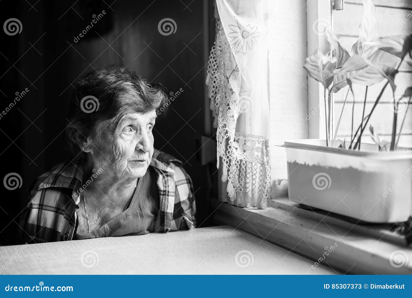 An Elderly Woman Sadly Looking Out The Window Stock Image Image Of