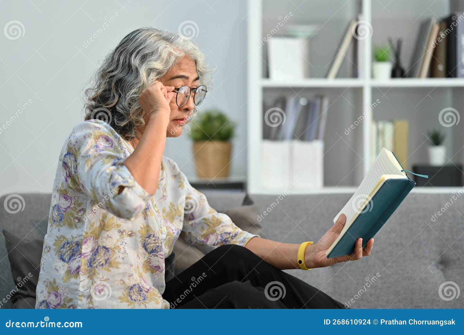 Elderly Woman Trying To Read Book Having Difficulties Seeing Text ...