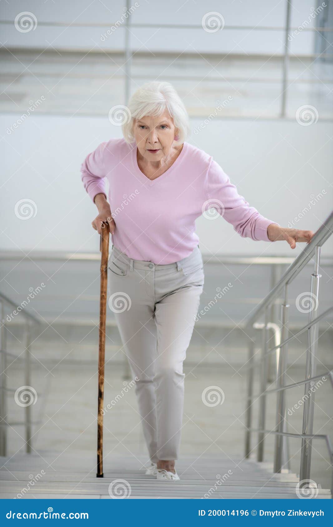 Elderly Woman with a Walking Stick Going Upstairs Stock Photo - Image ...