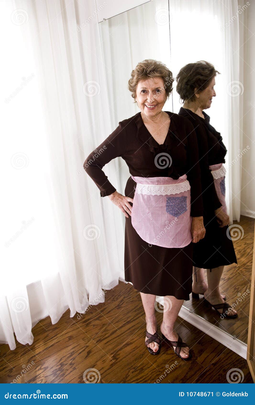 Elderly Woman Wearing Apron Stock Image - Image of standing, camera ...