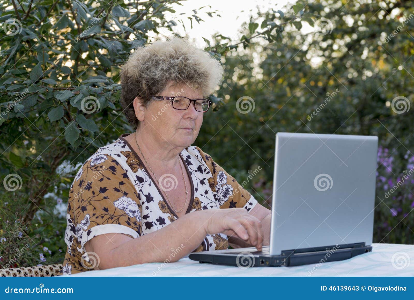 Elderly Woman Working on Computer in the Garden Stock Image - Image of ...