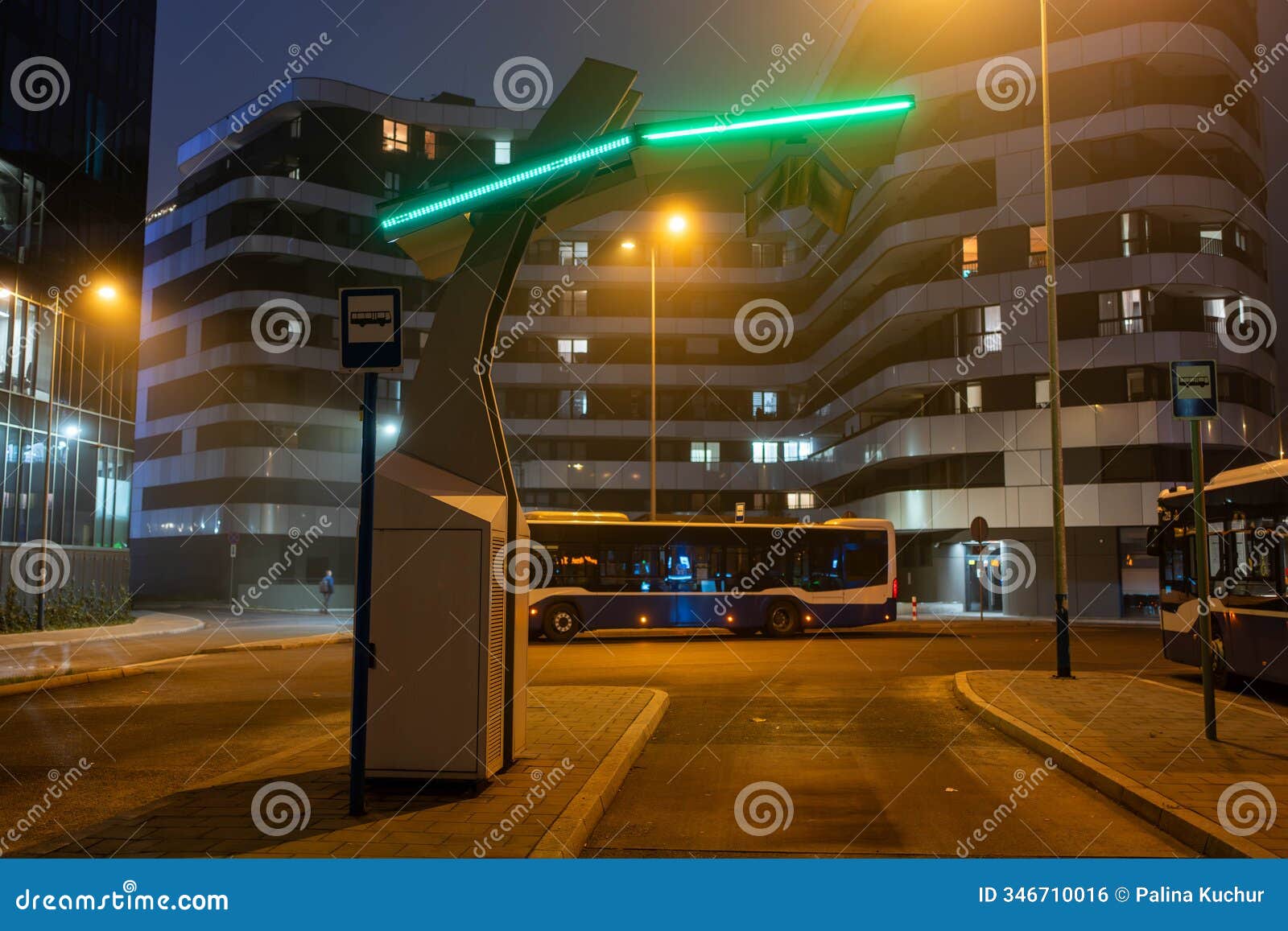 An Electric Bus Stands at an Empty Bus Stop and Charges, a Close Up ...