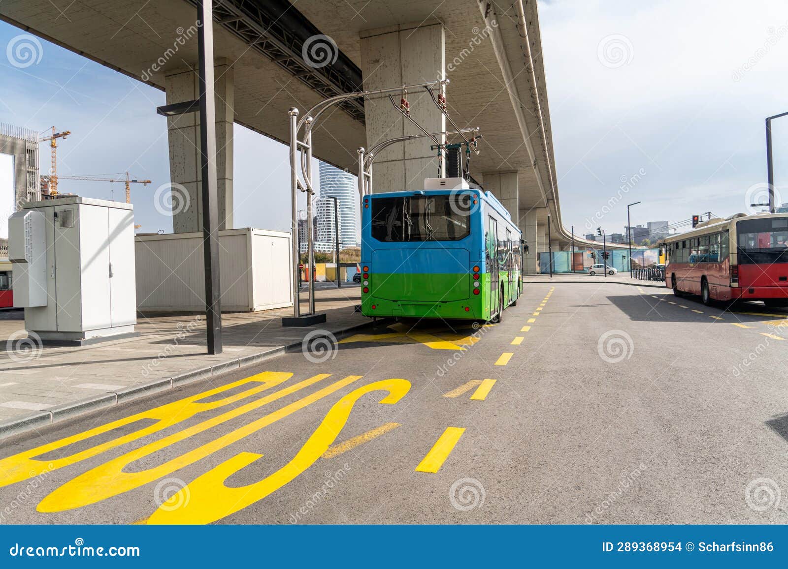 Electric Bus at a Stop is Charged by Pantograph. Clean Mobility Stock ...