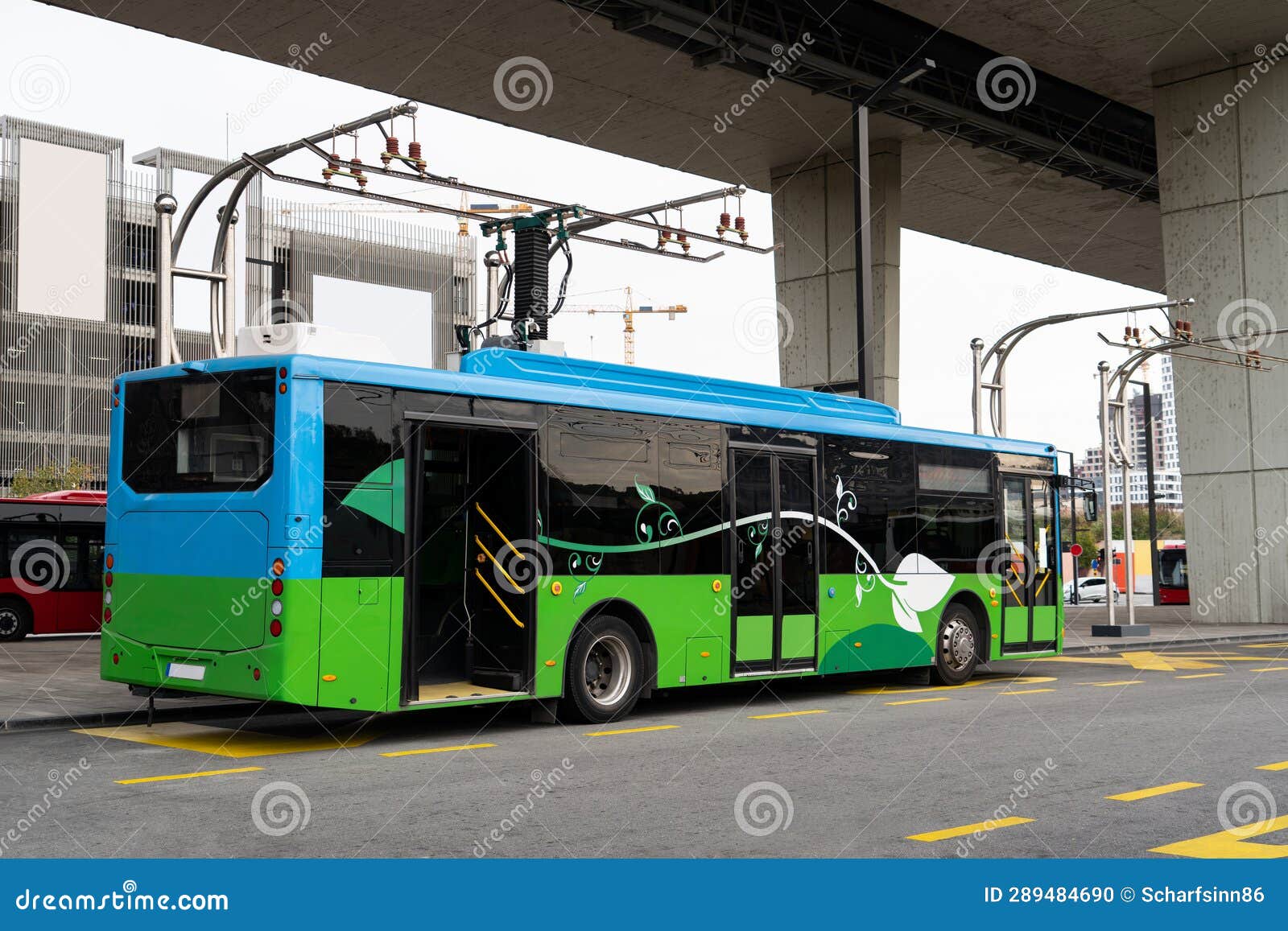 Electric Bus at a Stop is Charged by Pantograph. Clean Mobility Stock ...