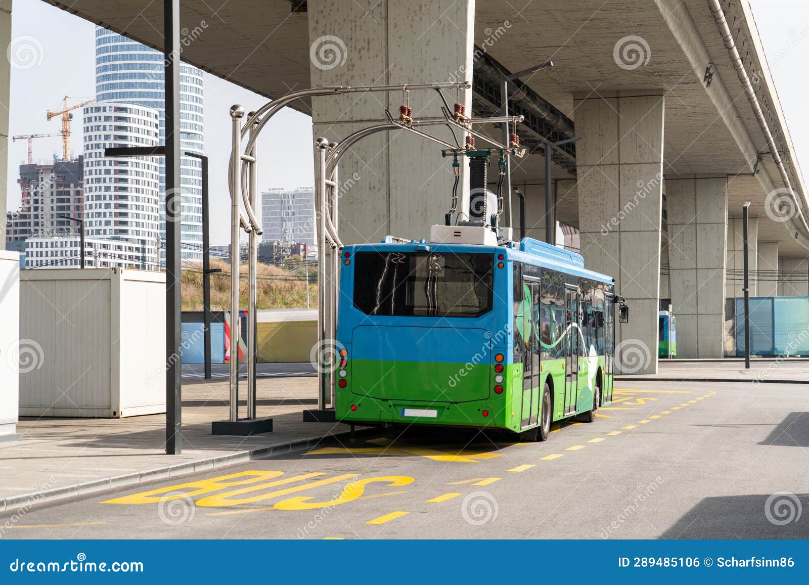 Electric Bus at a Stop is Charged by Pantograph. Clean Mobility Stock ...