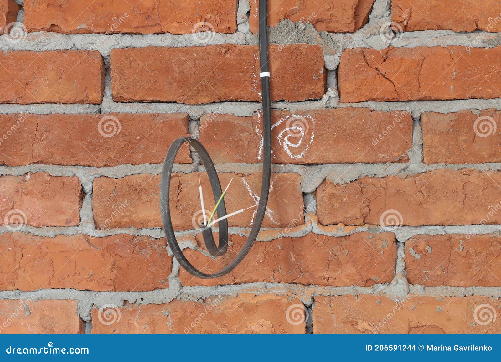 An Electric Cable is Installed on the Brick Wall of a New House Under ...
