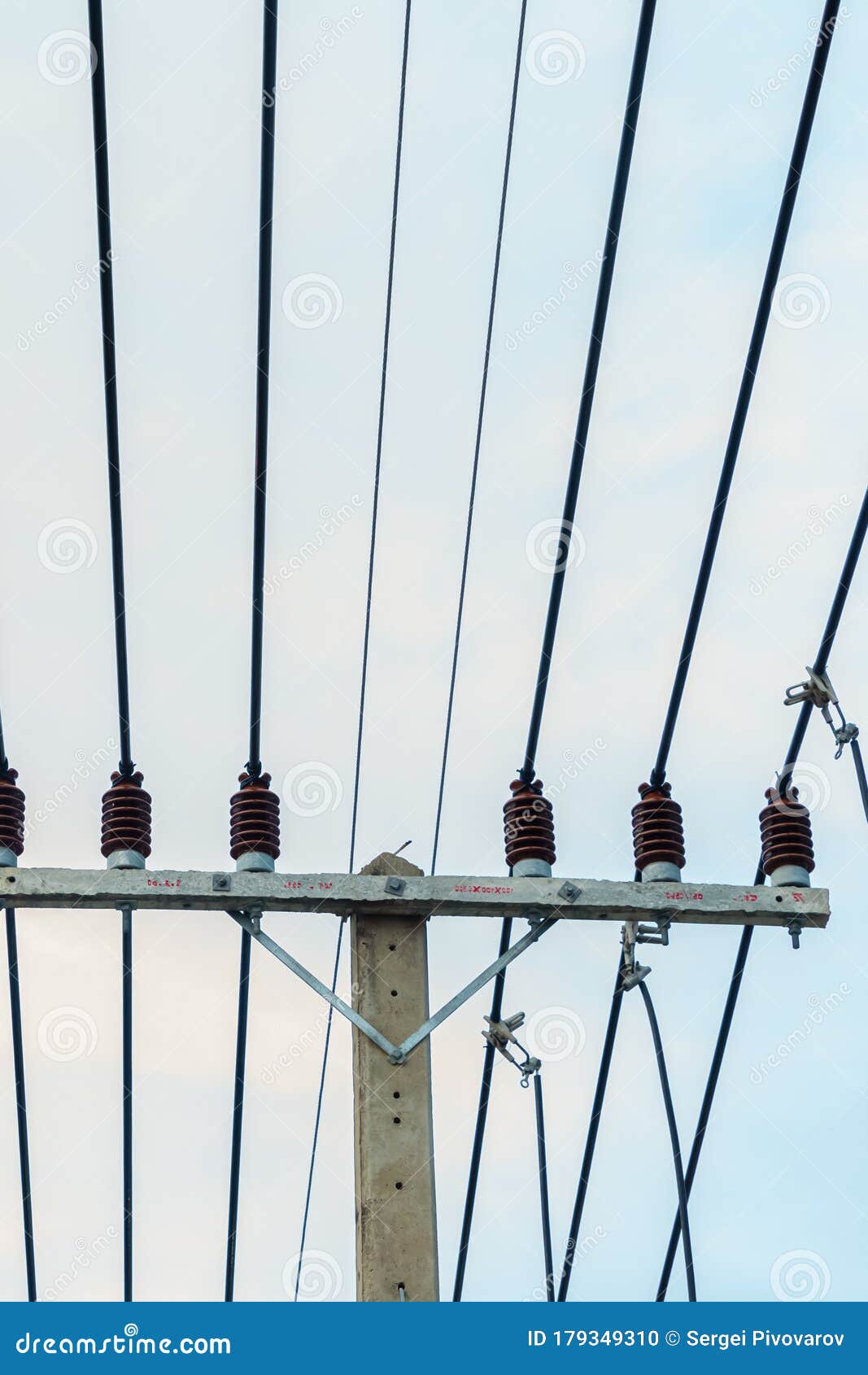Electric Cable is Stretched Over Cement Poles Against a Light Sky ...