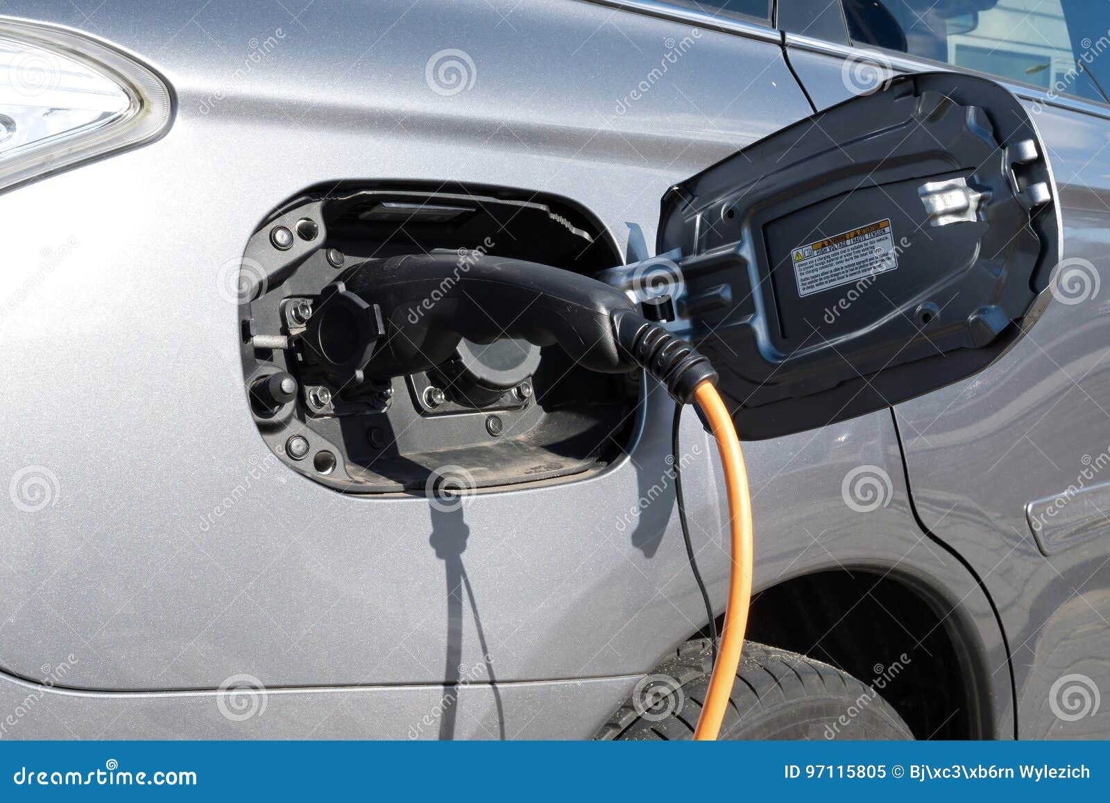Electric car being charged stock image. Image of load - 97115805