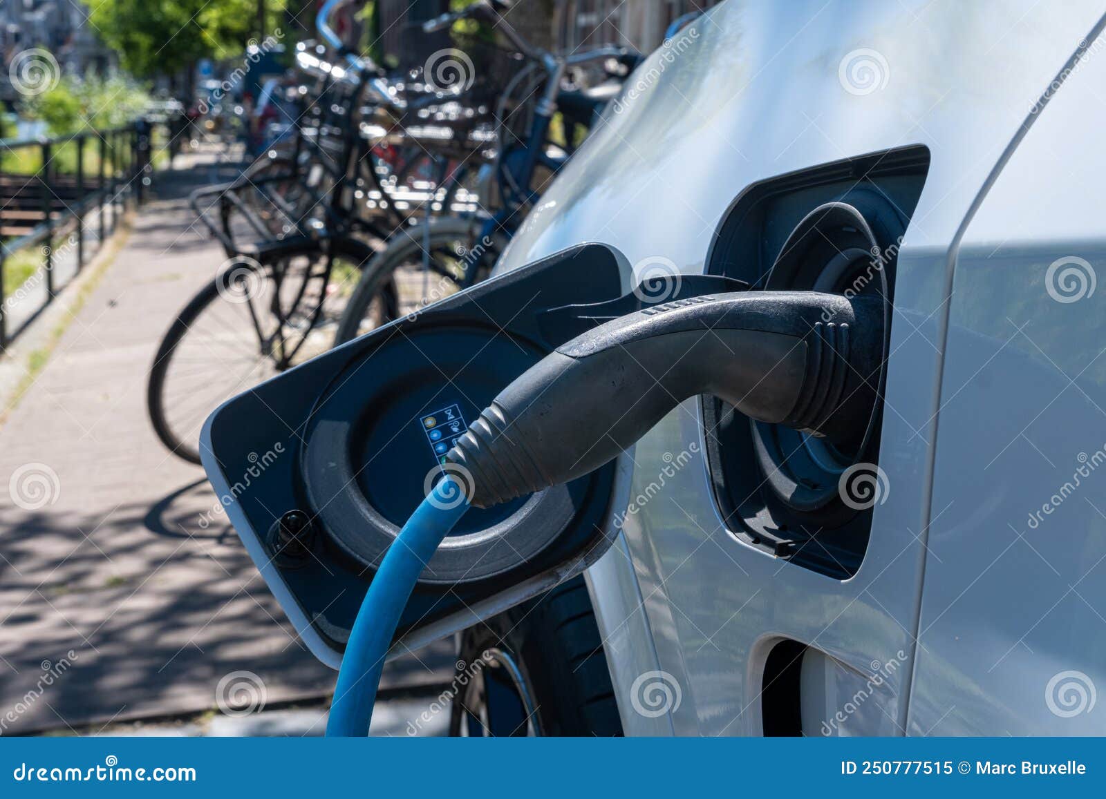 Electric Car Plugged in and Charging Next To Bikes Editorial Image ...