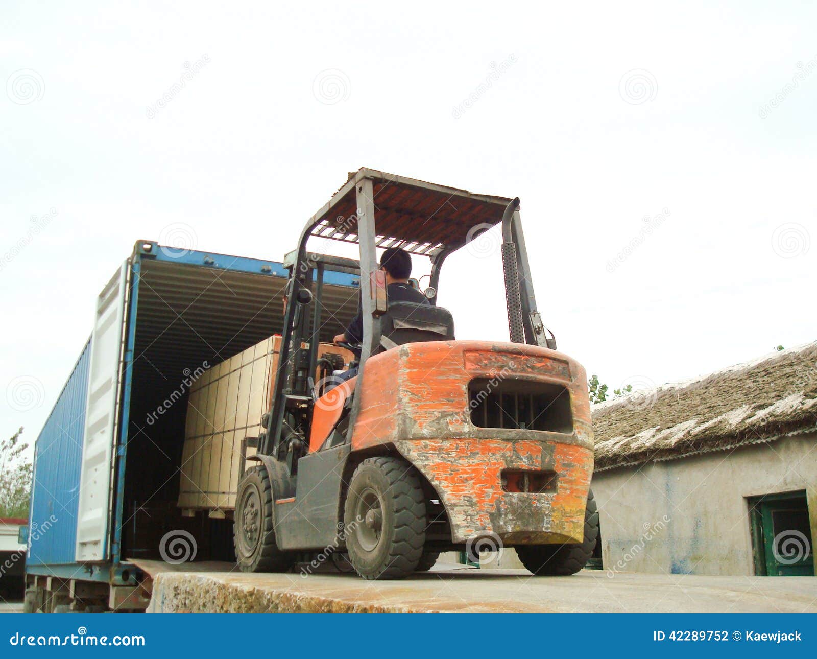 Electric Forklift Loading Cargos into Container Stock Photo - Image of ...