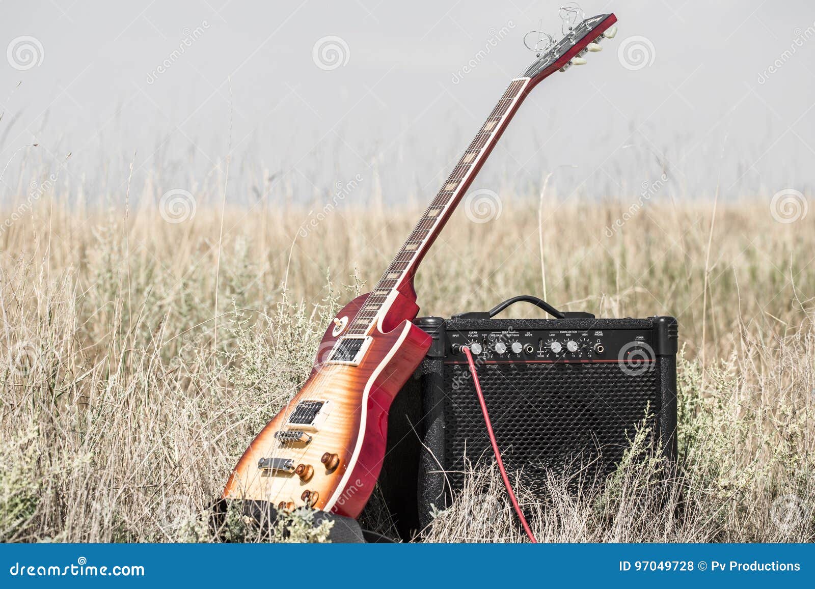 Electric Guitar and Amp on the Field, the Concept of Music Stock Photo ...