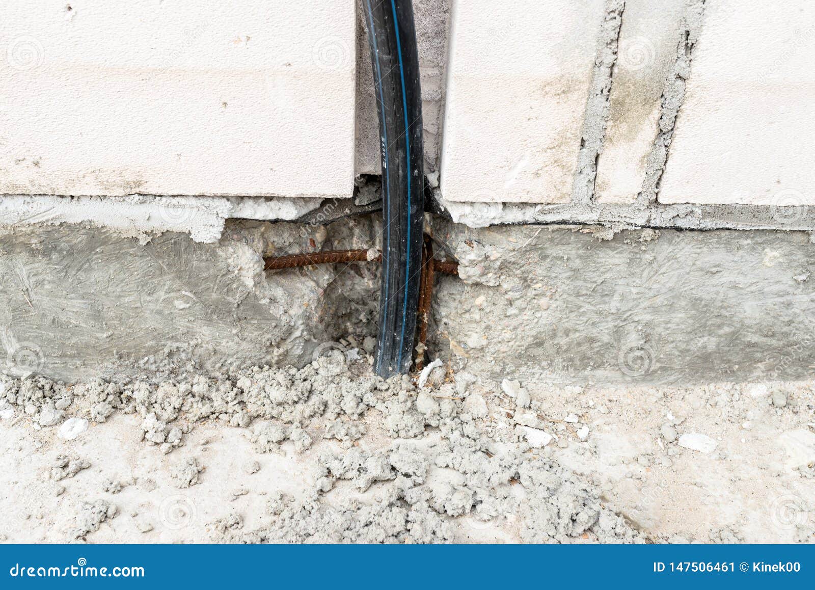 An Electric High Voltage Cable Protruding from the Foundation of the ...