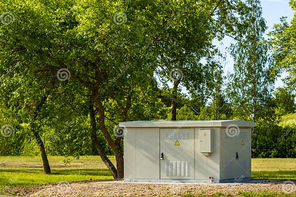 Electric High Voltage Distribution Box in a Public Park Under a Green ... Electric High Voltage Distribution Box in a Public Park Under a Green ...