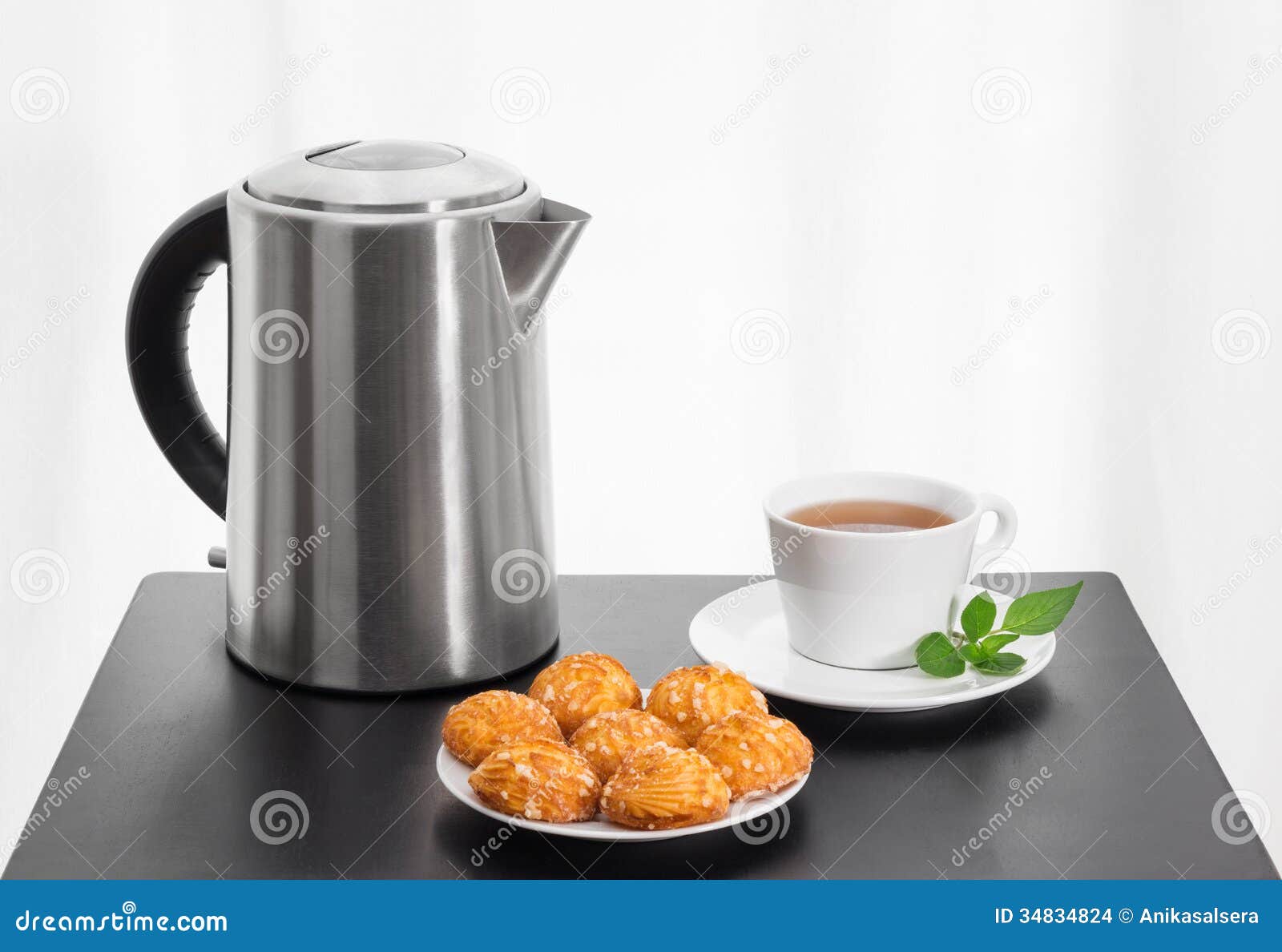 Electric Kettle, Cup of Tea and Cookies on a Table Stock Photo - Image ...