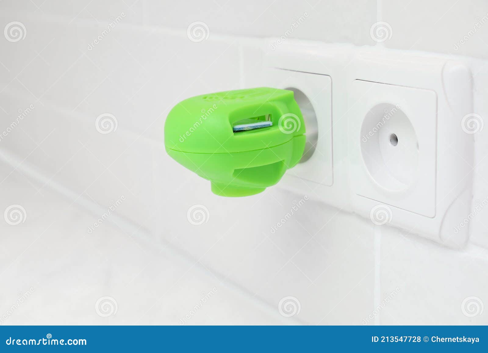 Electric Mosquito Device with Insect Repellent Plate Plugged in Socket ...