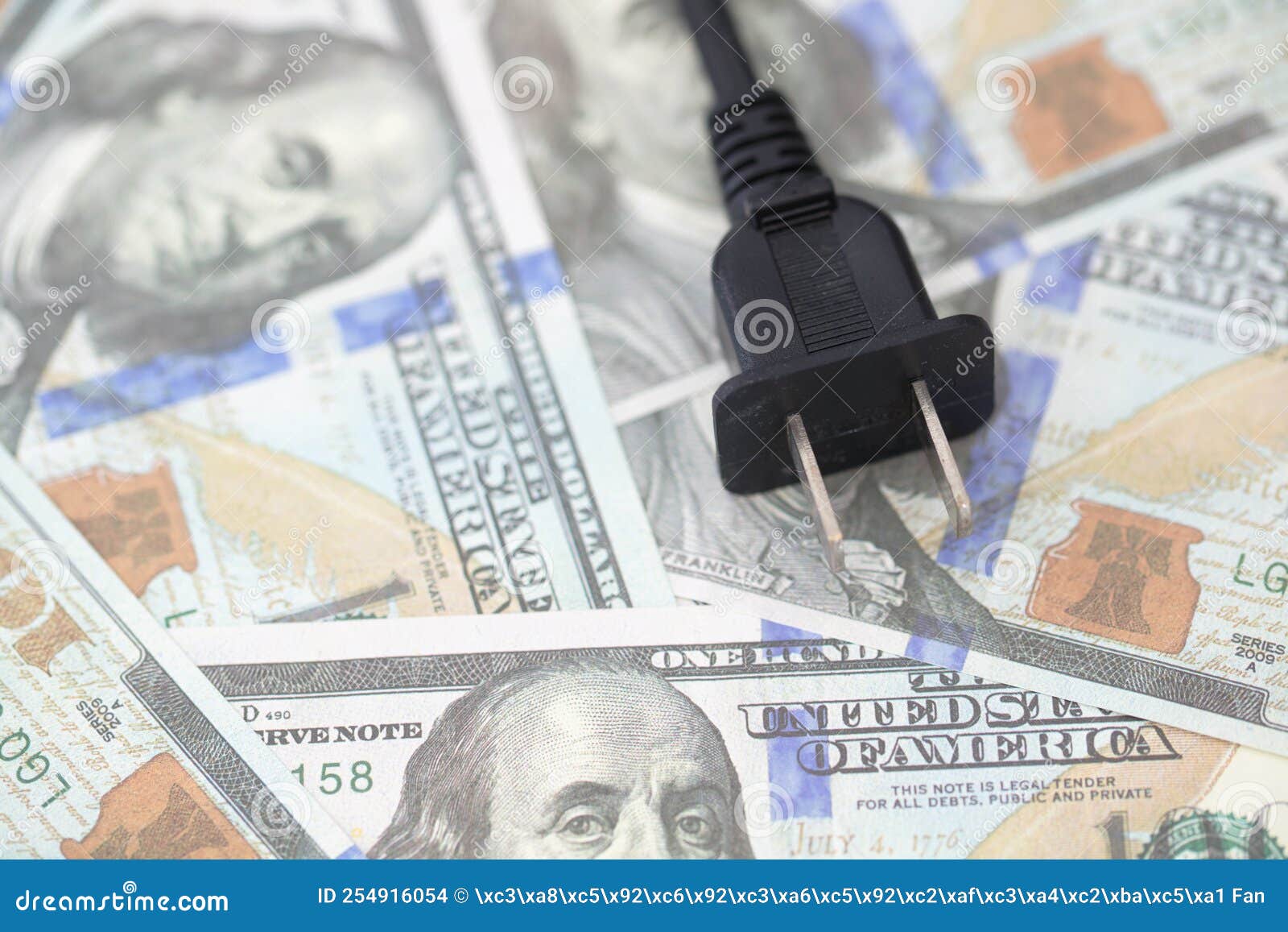 Electric Plug on a Background of Spread of Dollar Bills Stock Photo ...
