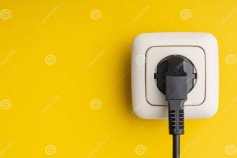 Electric Plug and Wall Socket on Yellow Wall Stock Image - Image of ...