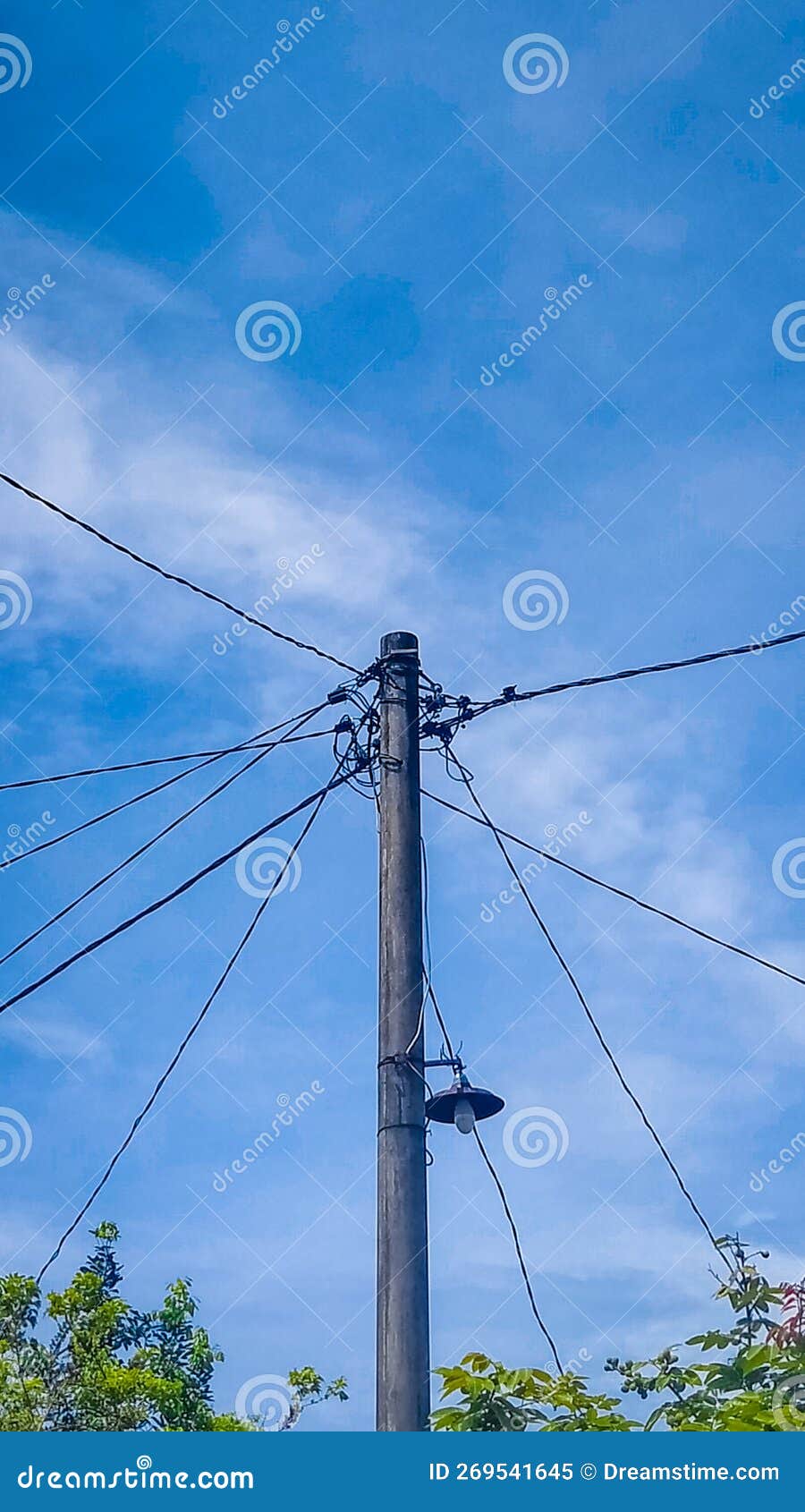 An Electric Pole with a Lamp and Some Wires in Fine Weather and Several ...