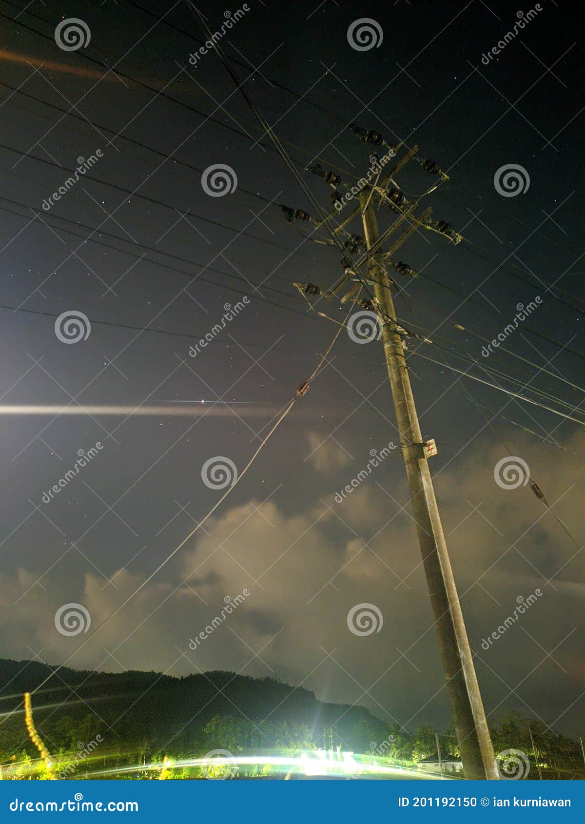Electric poles at night stock photo. Image of beautiful - 201192150