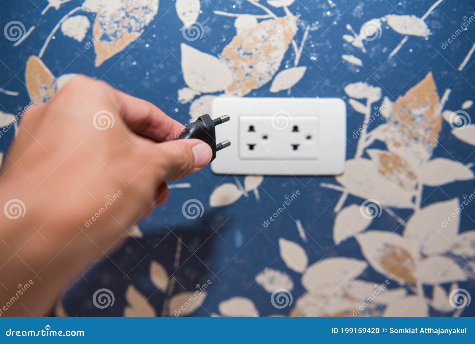 Electric Power Plug in a Hand and Inserting into Power Wall Socket ...