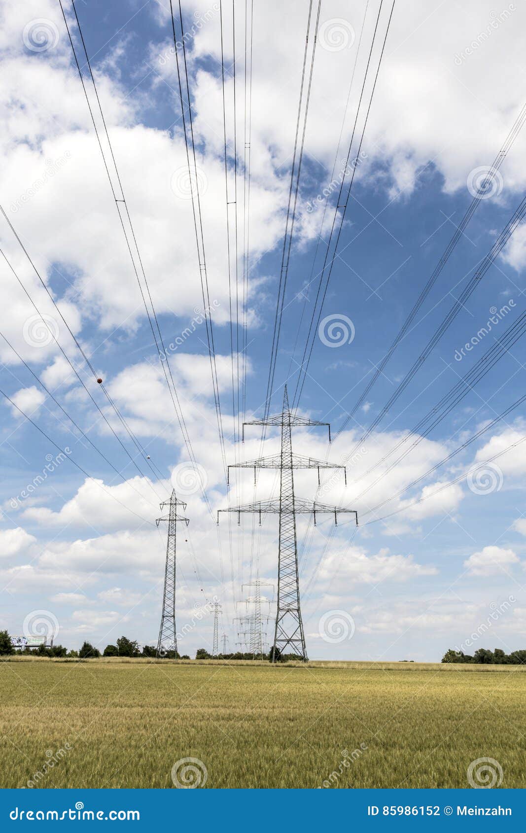 Electric Pylon on Field Under Blue Sky Stock Photo - Image of line ...