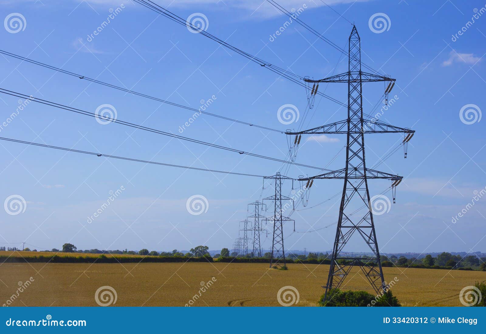 Electric pylons in a field stock photo. Image of copyspace - 33420312