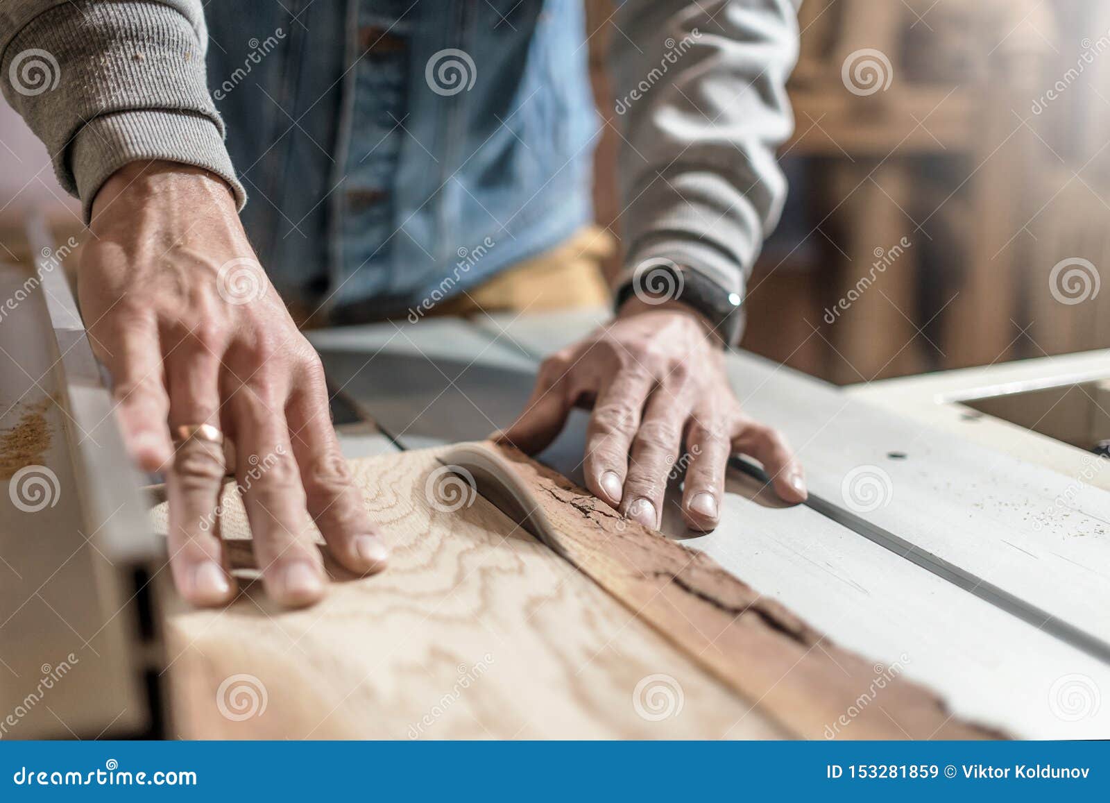 Electric Saw Cutting Wood Board. Man Working at Carpentry Workshop ...