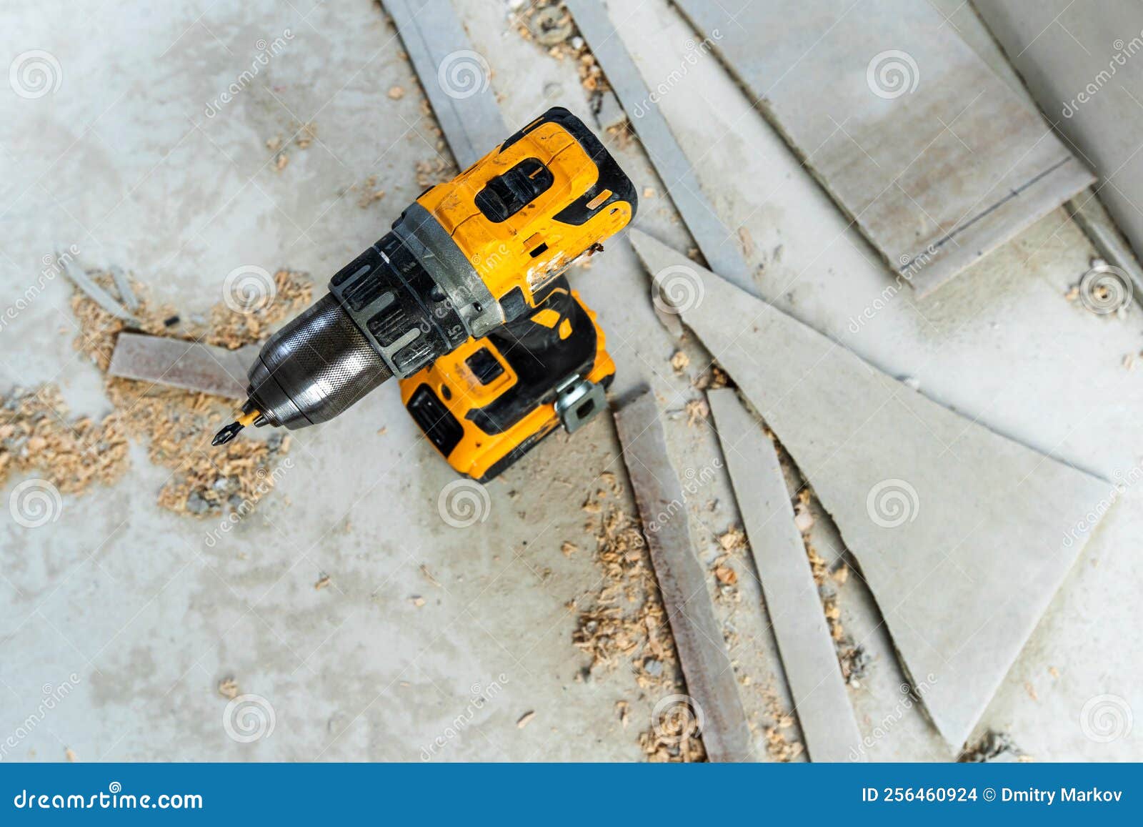 Electric Screwdriver on the Background of Construction Debris. Assembly ...