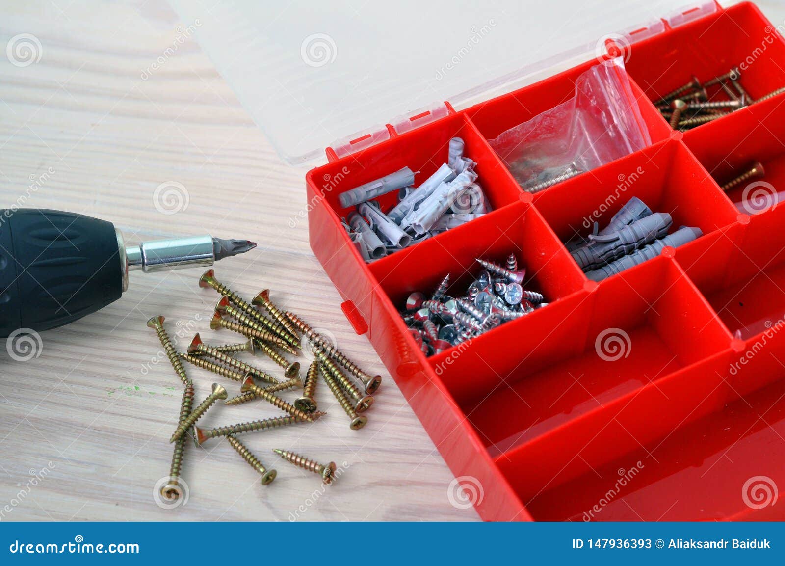 Electric Screwdriver and Screws on a Wooden Table. Stock Image - Image ...