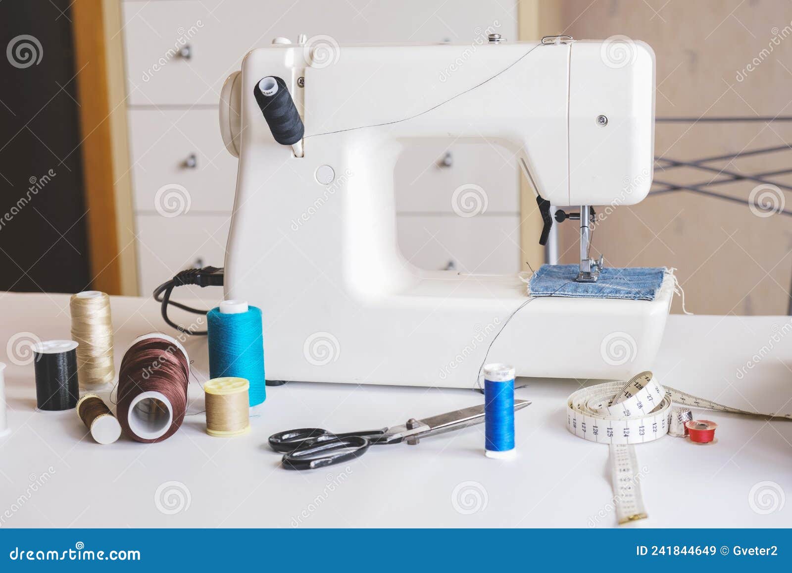 Electric Sewing Machine and Spools of Thread on the Table Stock Image ...