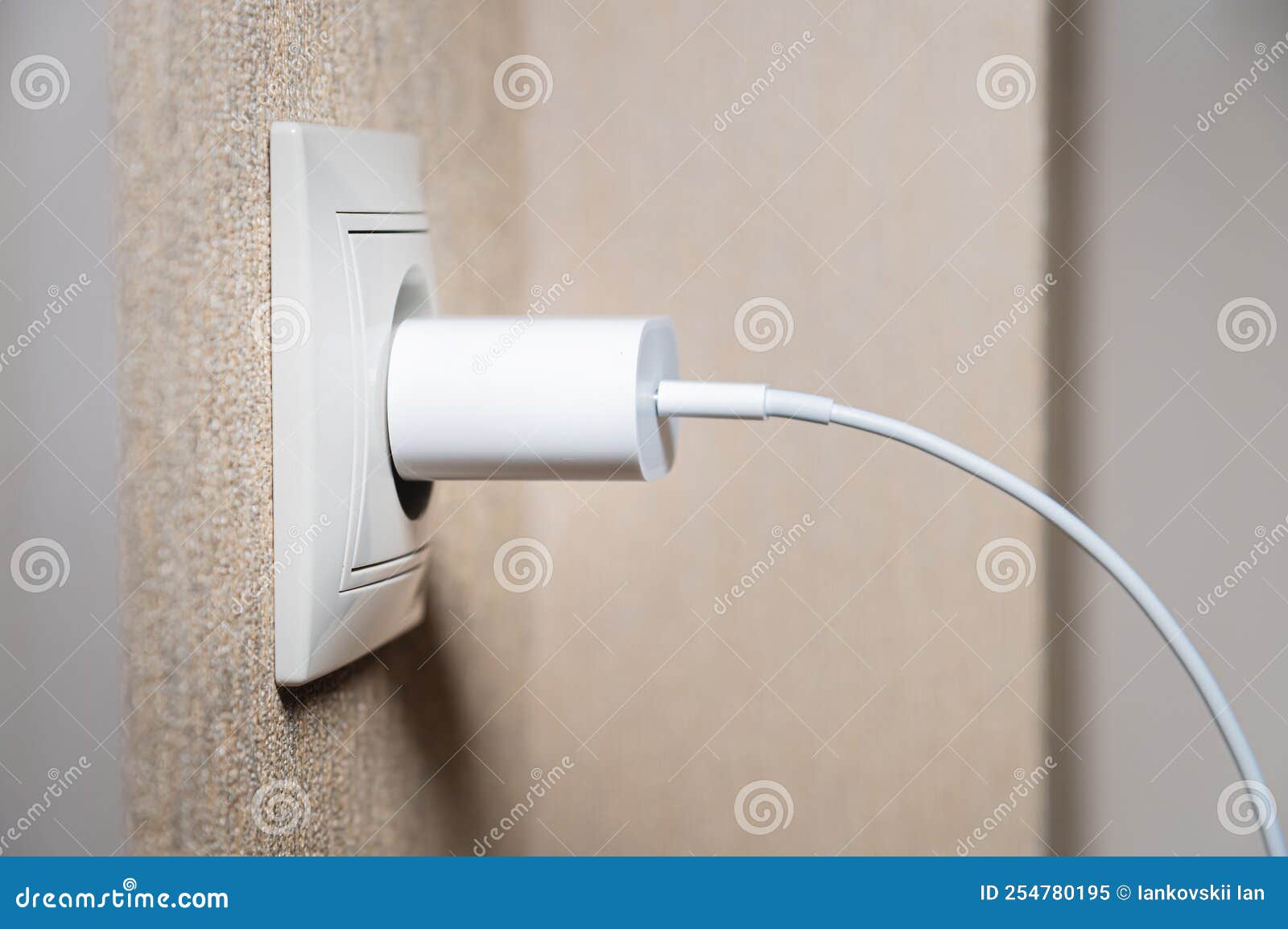 Electric Socket on a Pink Wall. the Black Wire Plug is Connected ...